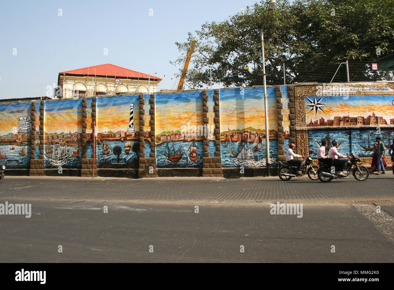Mural on Wall with People on Motorbikes Passing By, Mumbai, India Stock ...