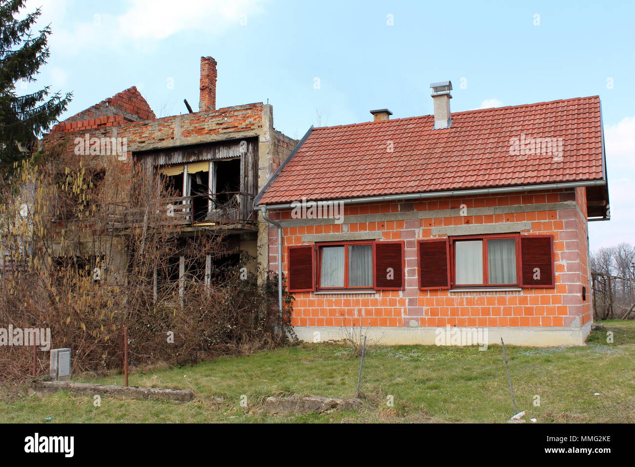 Unfinished new suburban family house built next to old completely ...