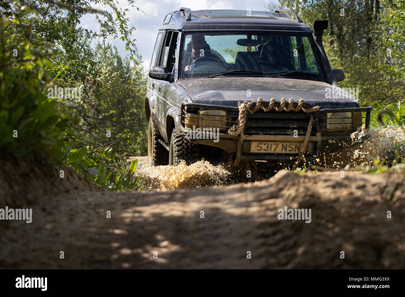 SUV Sport Utility Vehicle with 4 x 4 off road on muddy track Stock ...