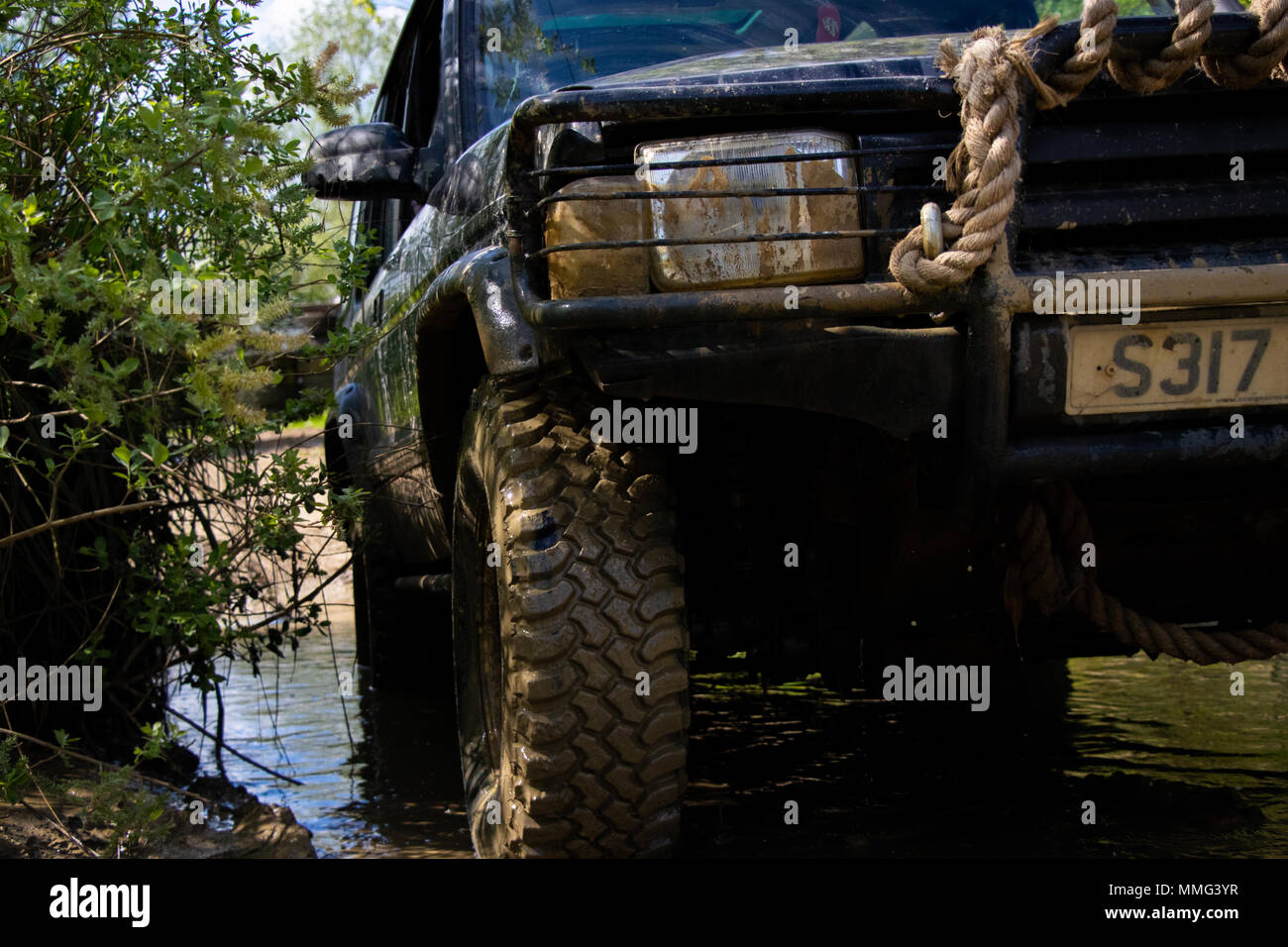 SUV Sport Utility Vehicle with 4 x 4 off road on muddy track Stock ...