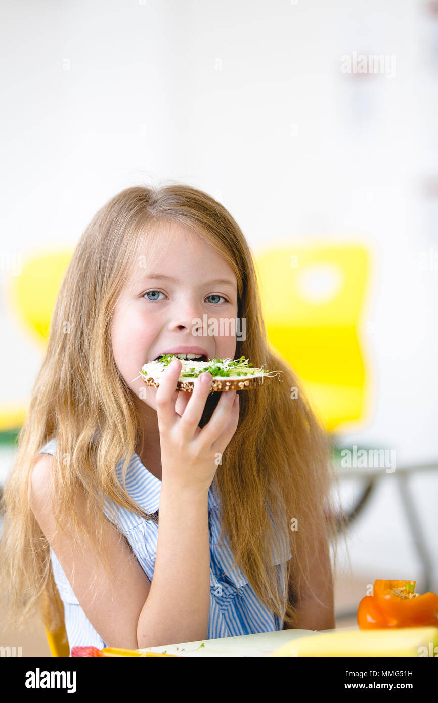 At school - Happy pupil prepare a healthy snack for the break Stock ...