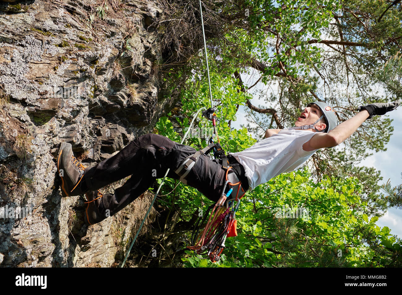Young man climbing on rock hi-res stock photography and images - Alamy