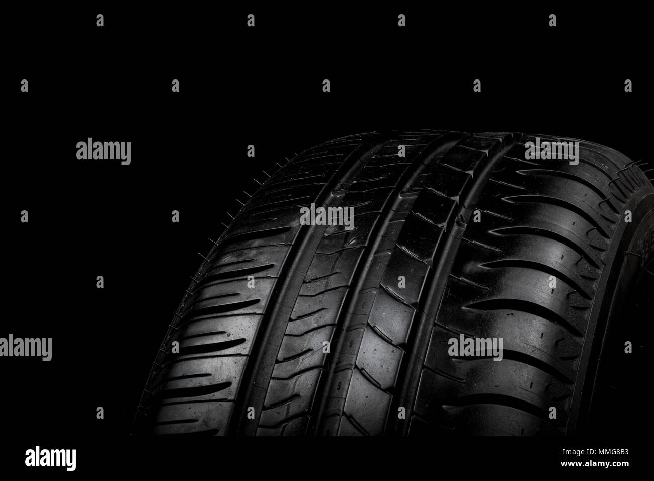 Close up view of a car tyre isolated on a black background Stock Photo ...
