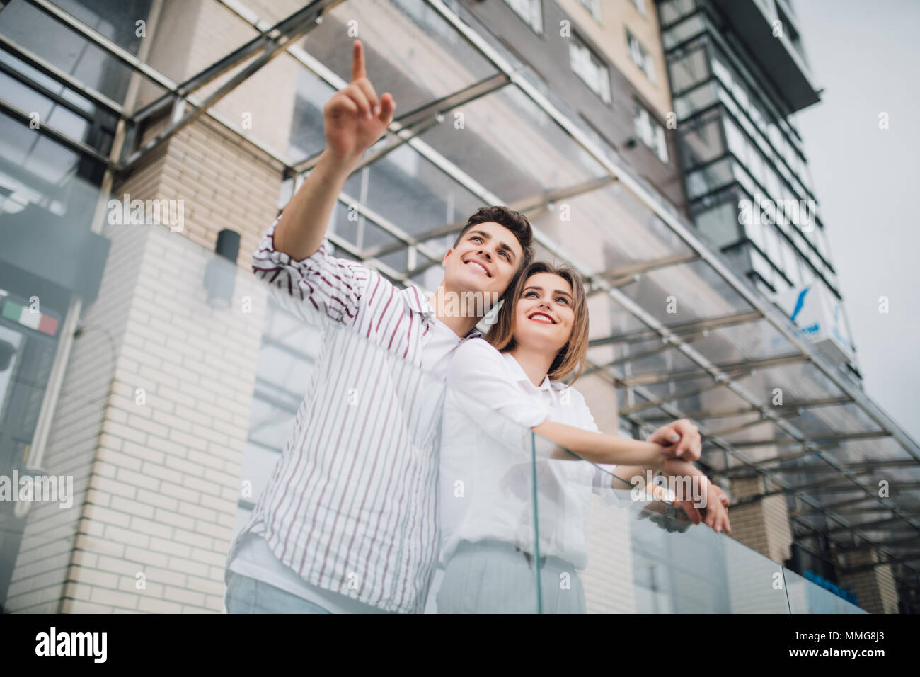 Real estate and family concept. Young couple on front of new big modern ...