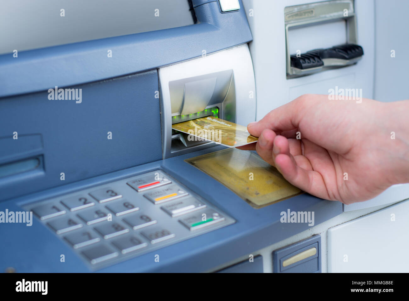 Hand inserting ATM credit card Stock Photo - Alamy
