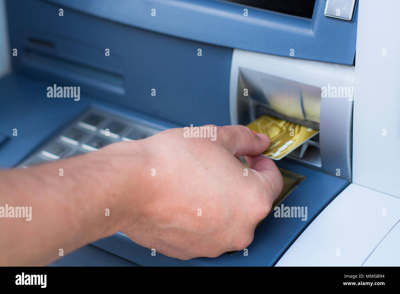 Hand inserting ATM credit card Stock Photo - Alamy