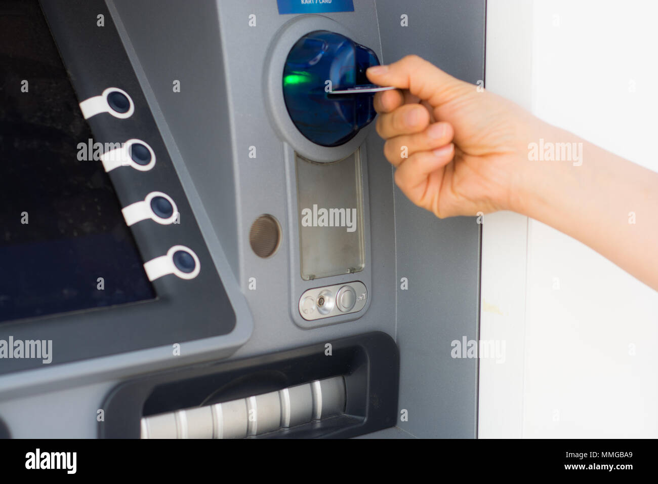 Hand inserting ATM credit card Stock Photo - Alamy