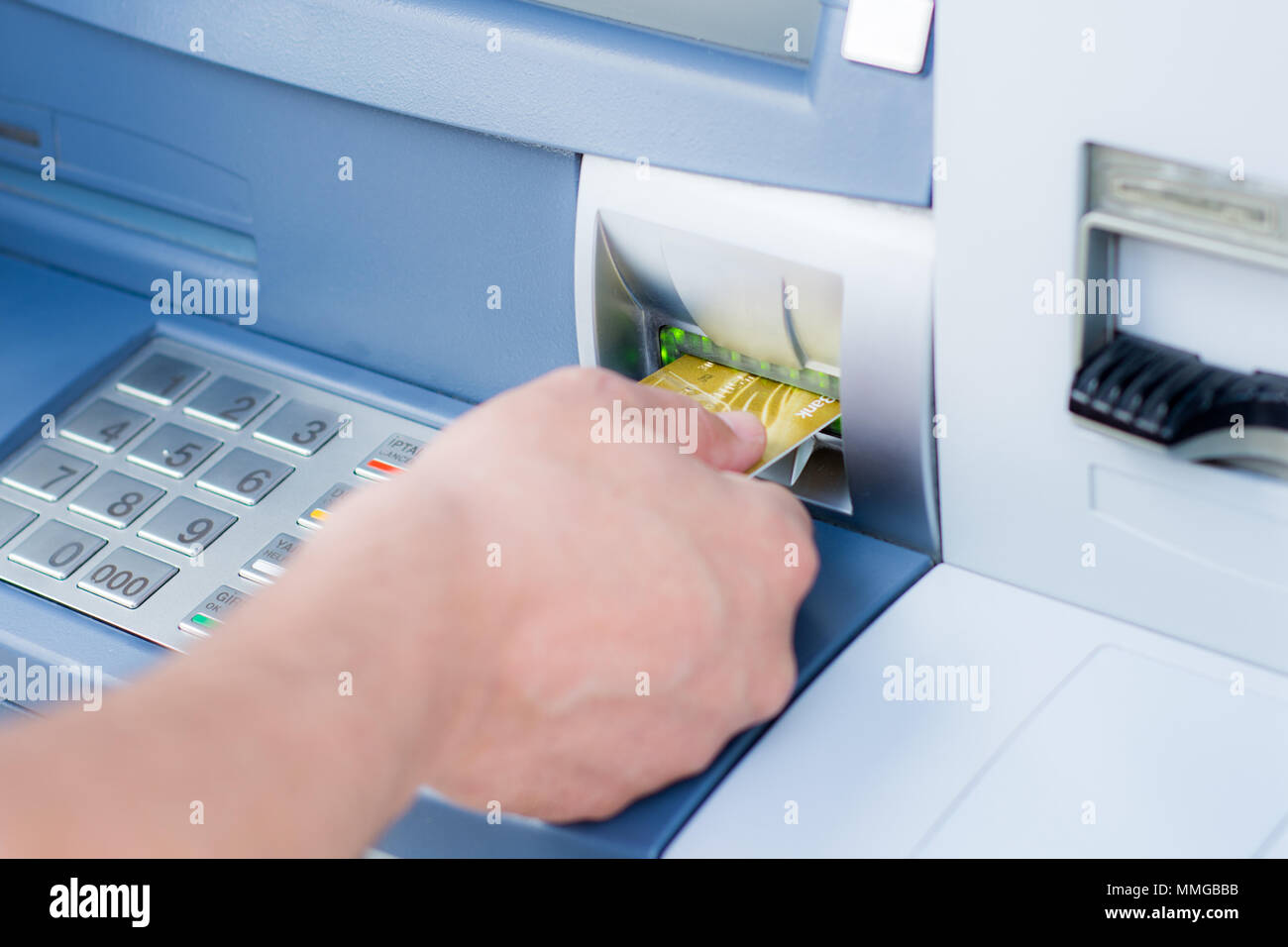 Hand inserting ATM credit card Stock Photo - Alamy