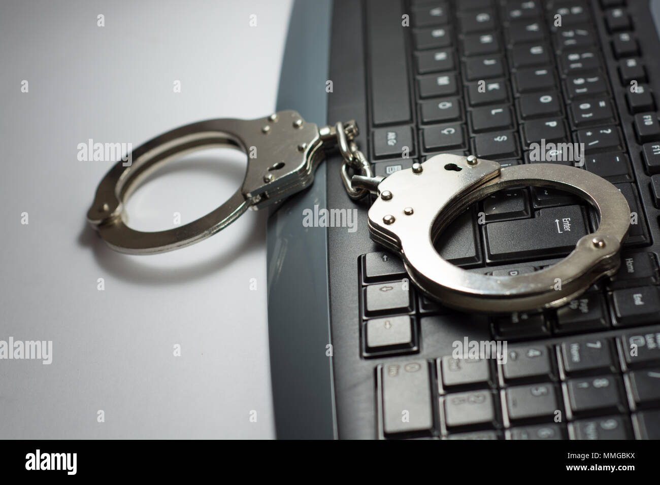 Handcuffs on keyboard hi-res stock photography and images - Alamy