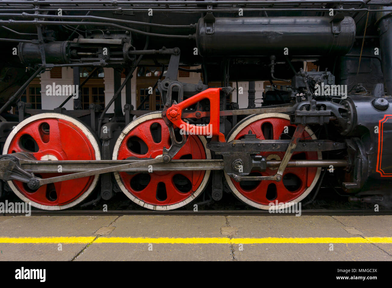 fragment of vintage functioning steam locomotive standing at station ...