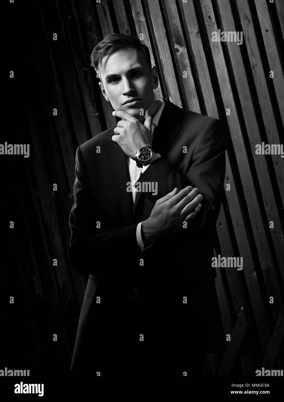 Serious handsome man with strained look posing in blue fashion suit and ...