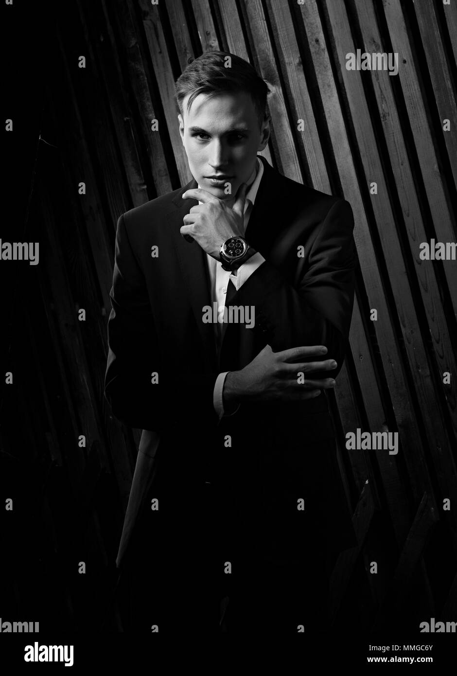 Confident handsome man with strained look posing in blue fashion suit ...