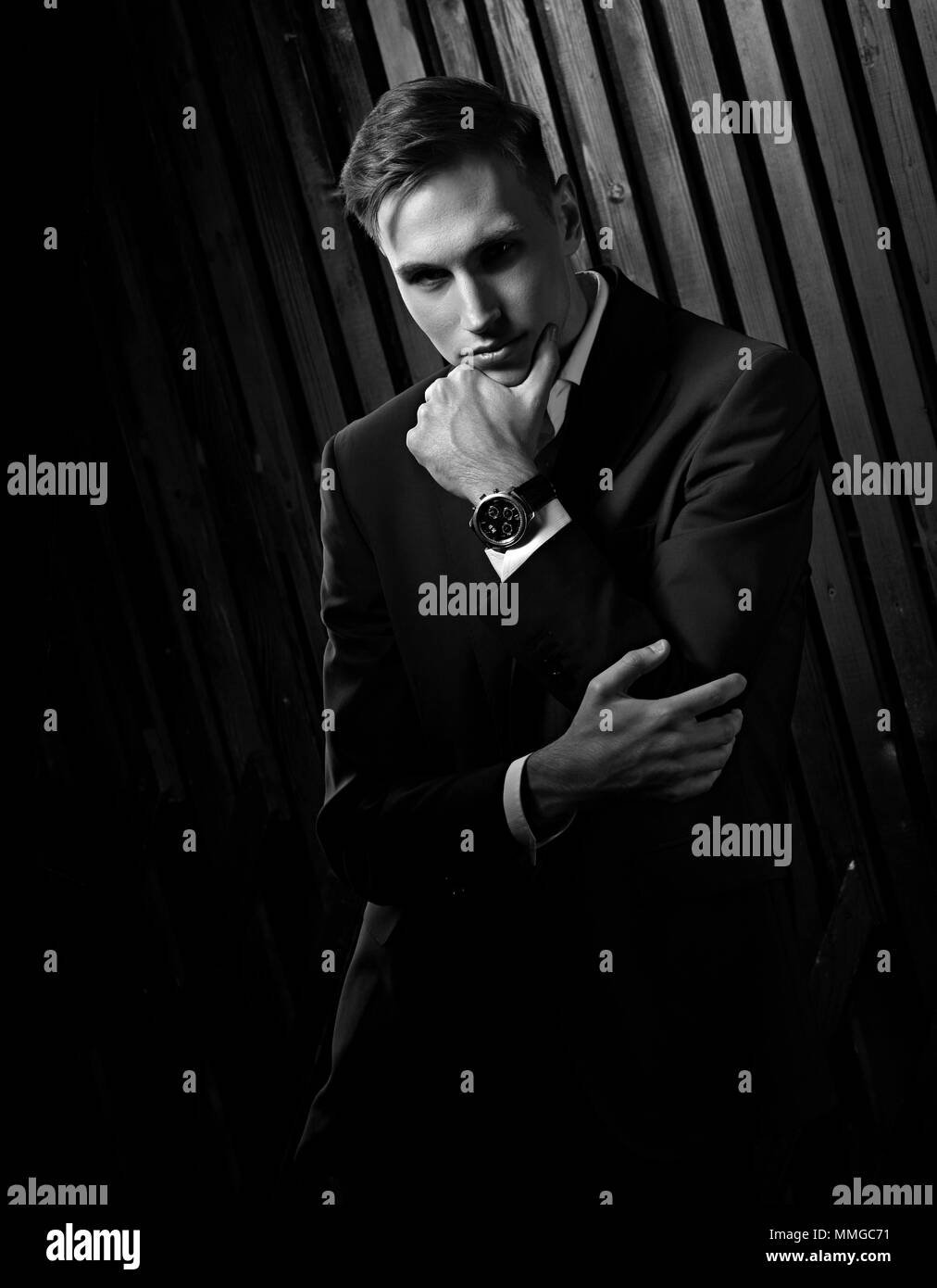 Confident handsome man with strained look posing in blue fashion suit ...