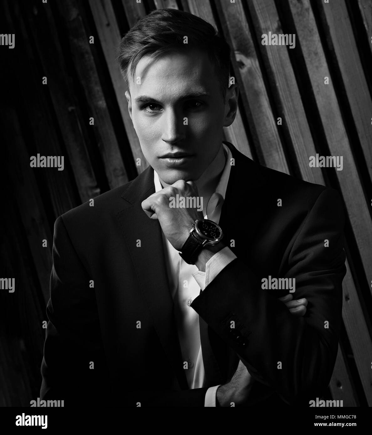 Confident handsome man with strained look posing in blue fashion suit ...