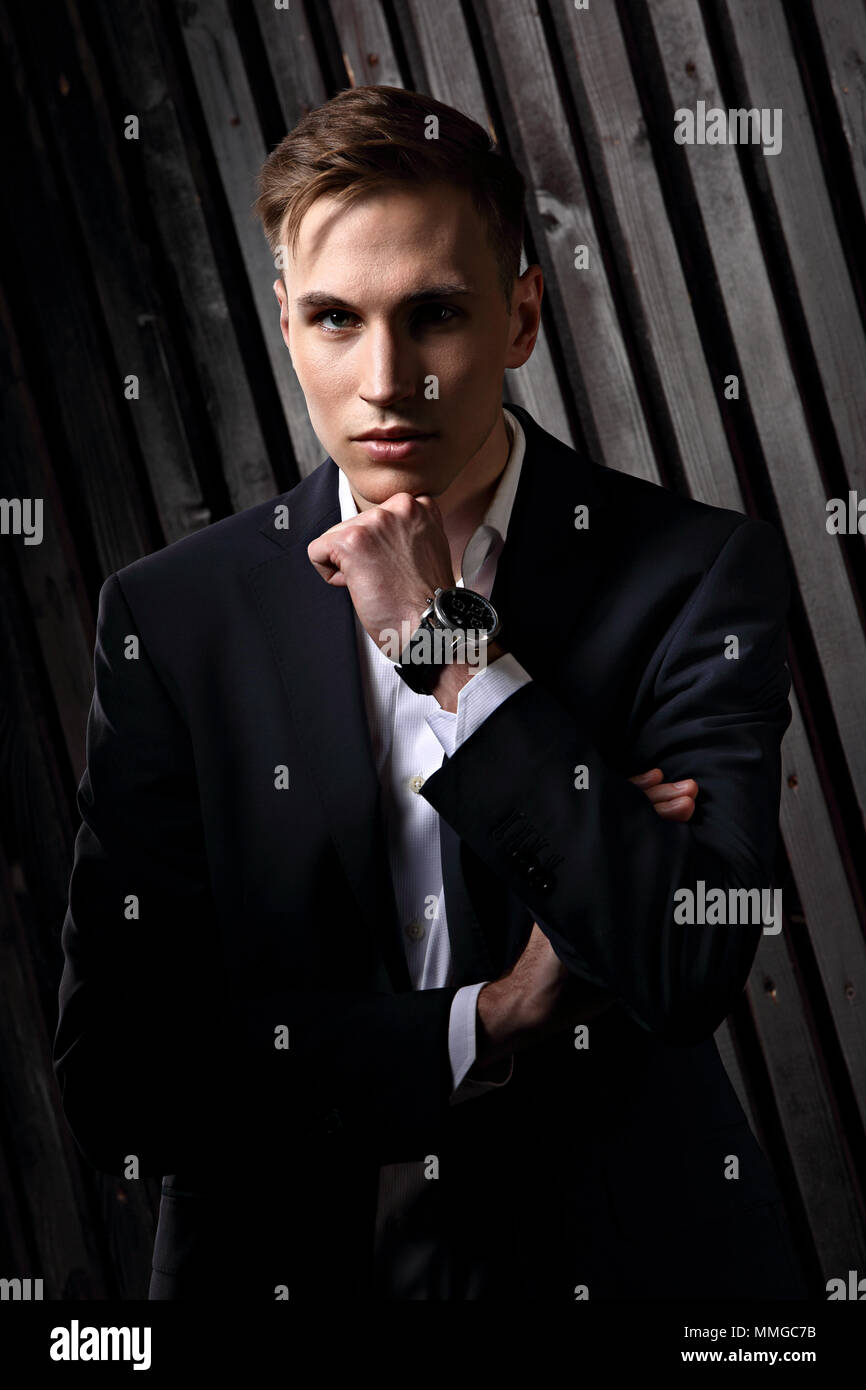 Confident handsome man with strained look posing in blue fashion suit ...