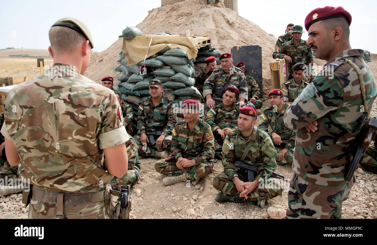 A British army trainer gives instruction during land navigation ...