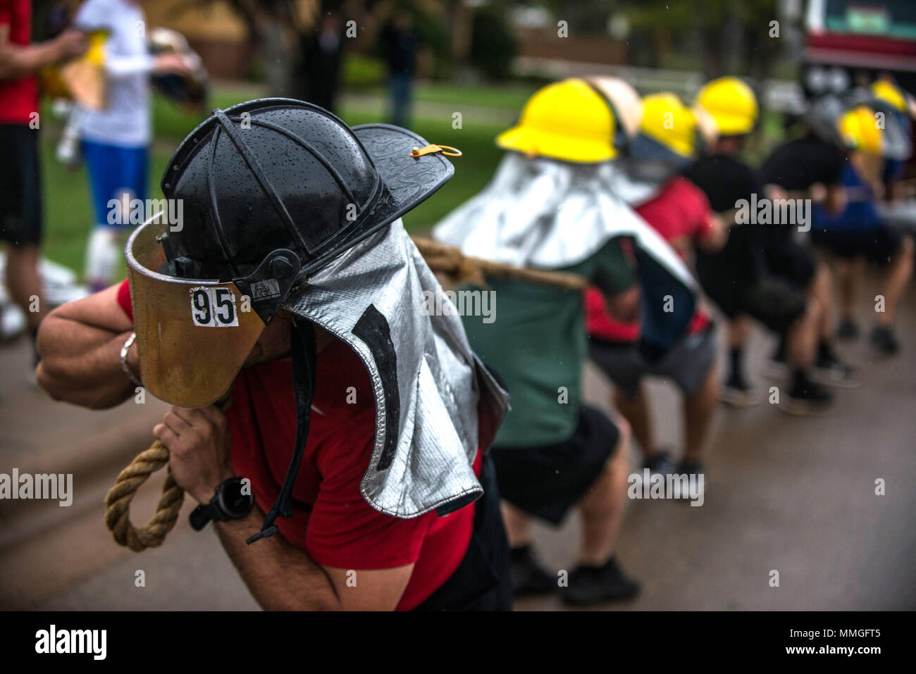 Air Commandos work together to pull a fire truck during the Fire Muster ...