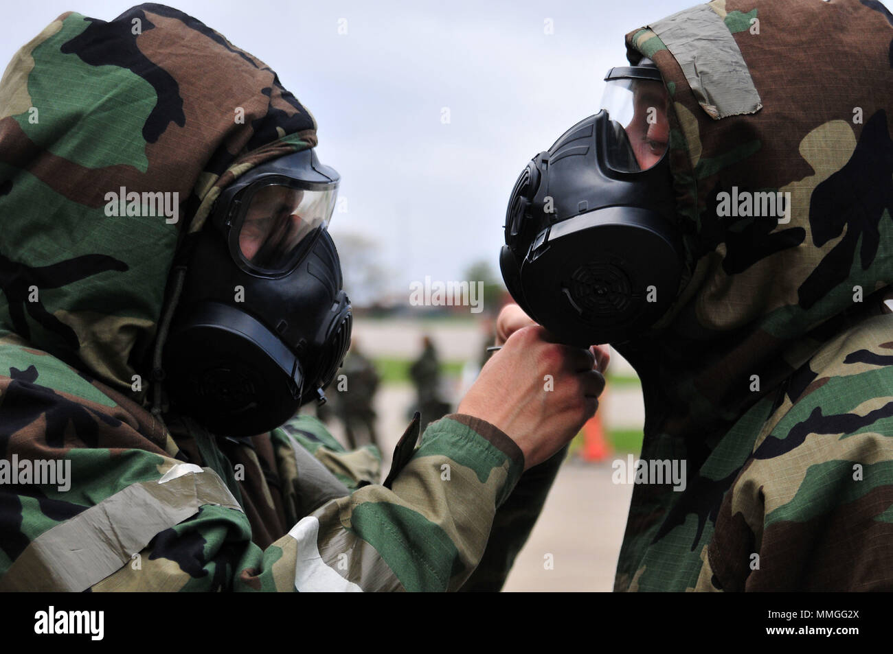 Two Airman, assigned to the 178th Wing, work together to zip up their ...
