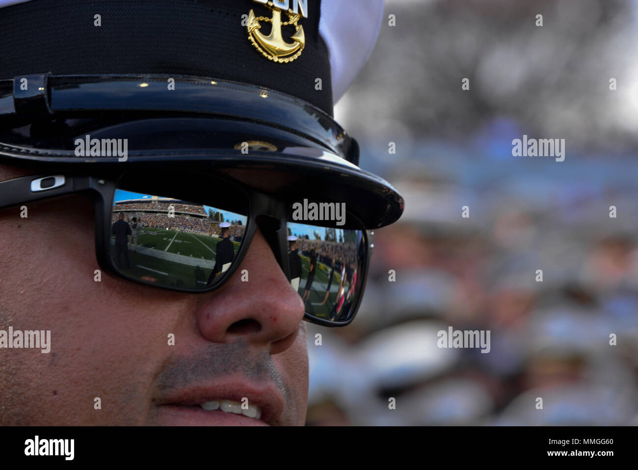 A U.S. Navy Midshipman watches the U.S. Naval Academy football team ...