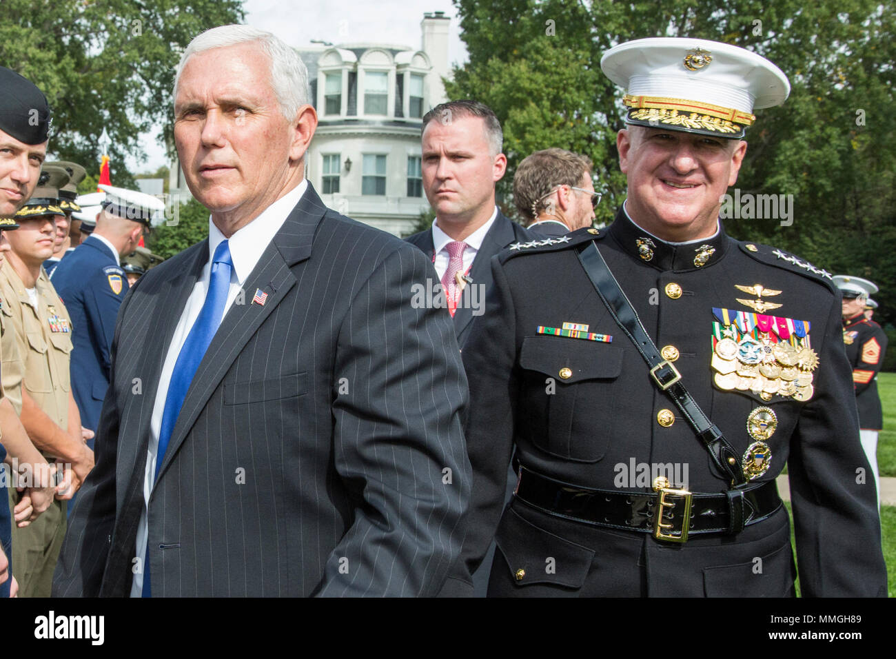 Vice President Mike Pence, left, walks with Assistant Commandant of the ...