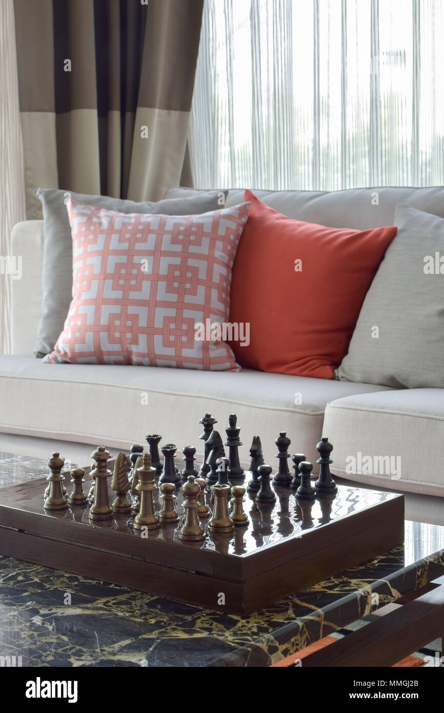 Classic chess set on the table in classic living room Stock Photo - Alamy