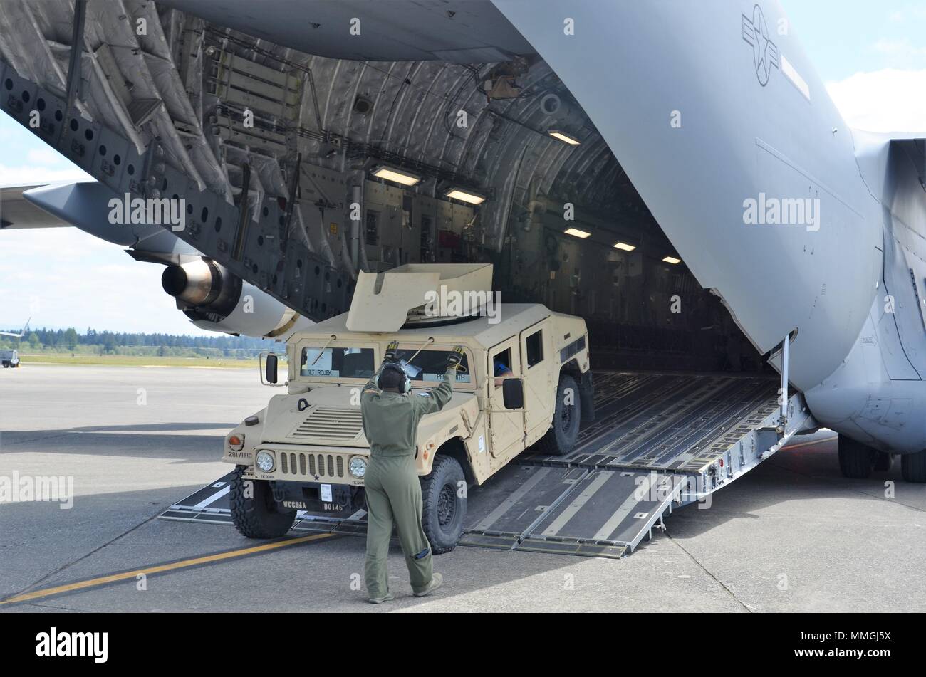 An Air Force loadmaster from the 62nd Airlift Wing at Joint Base Lewis ...