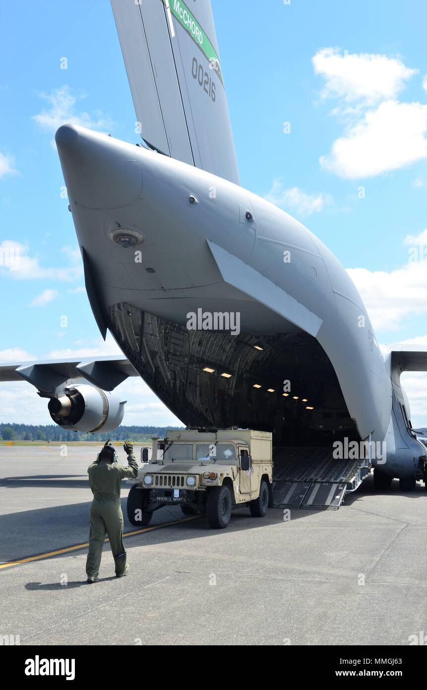 An Air Force loadmaster from the 62nd Airlift Wing at Joint Base Lewis ...