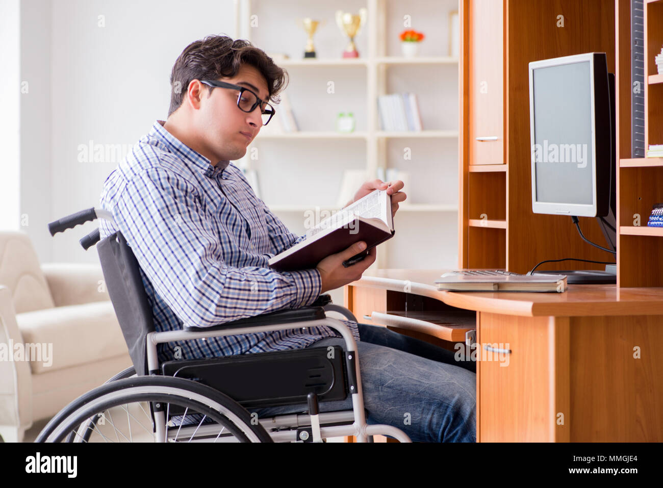 Disabled student studying at home on wheelchair Stock Photo - Alamy