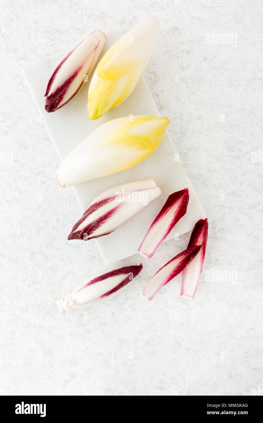 Top view of red chicory and chicory on a marble chopping board Stock ...