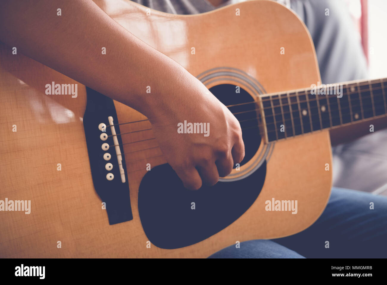 Womans hand playing guitar hi-res stock photography and images - Alamy