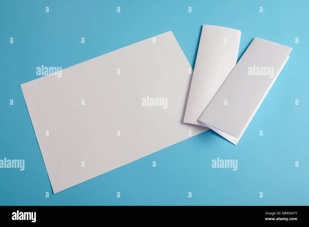 template fold white paper on blue background Stock Photo - Alamy