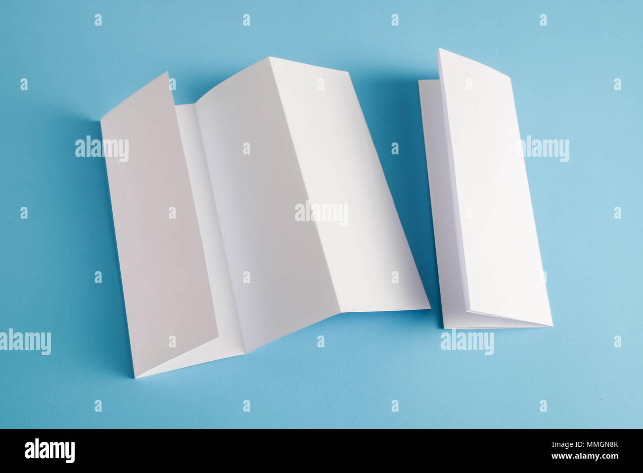 template fold white paper on blue background Stock Photo - Alamy