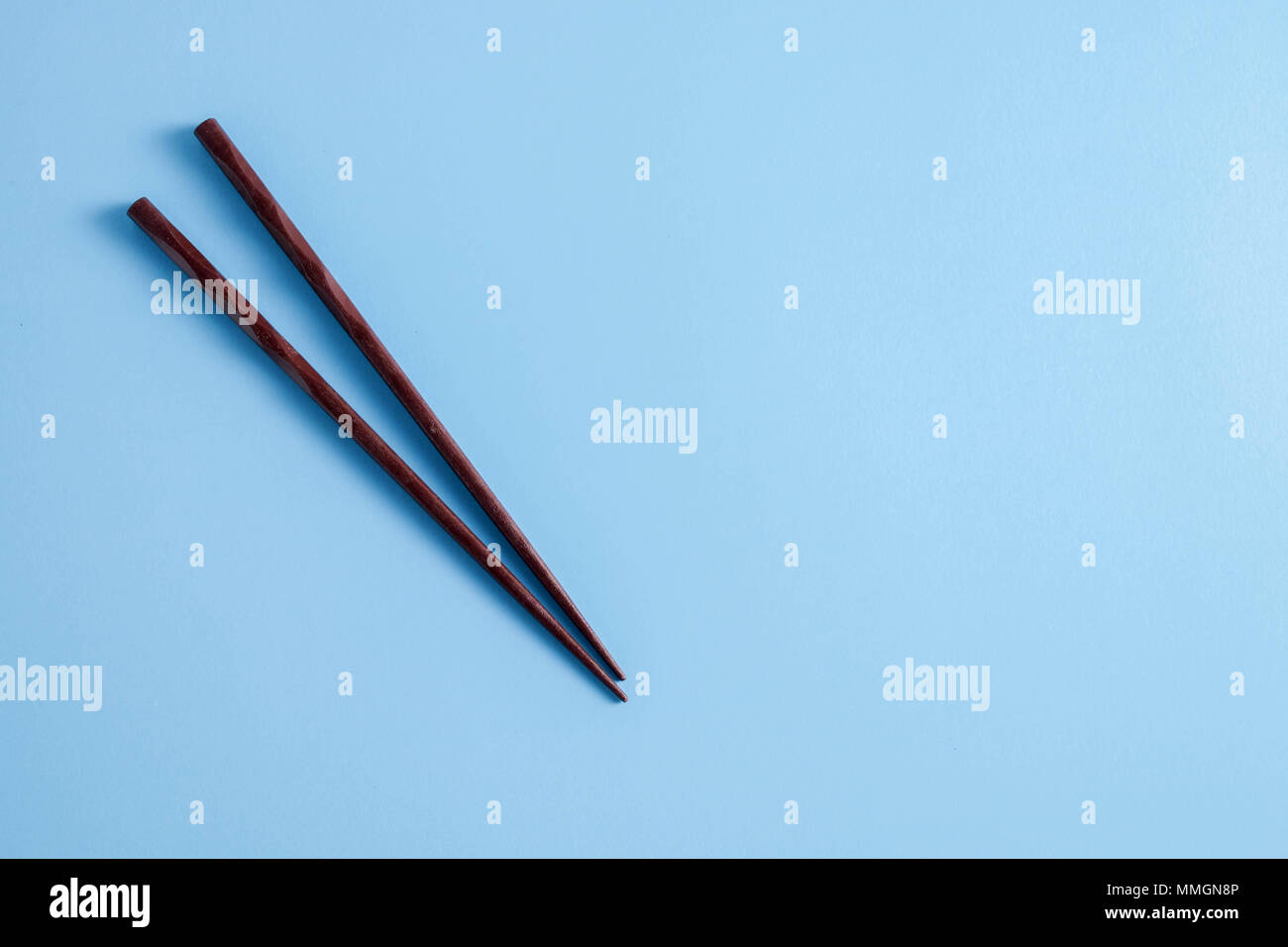 Chopsticks on a blue background, for a food menu background Stock Photo ...