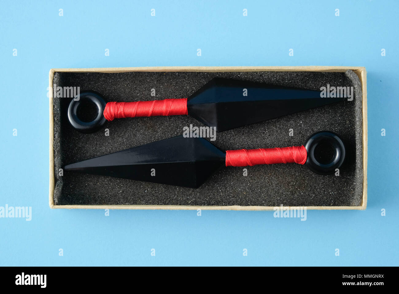 To throw ninja weapons isolated on blue paper background Stock Photo ...