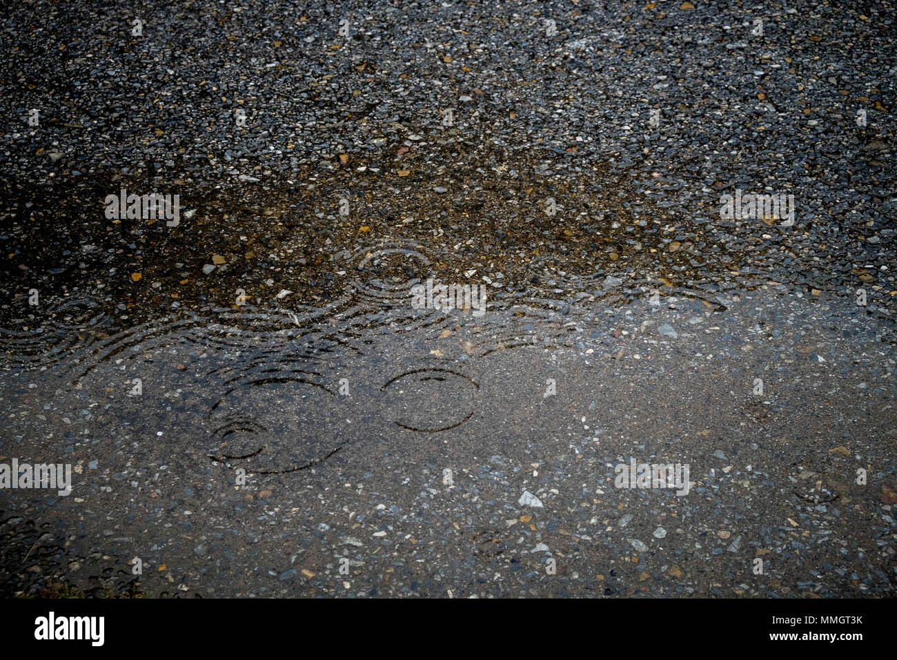 abstract texture background rain drops rippling in a puddle with blue ...
