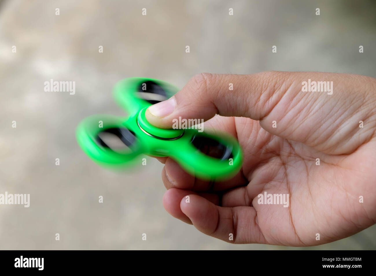 Fidget Spinner speed Spin in hands Stock Photo - Alamy
