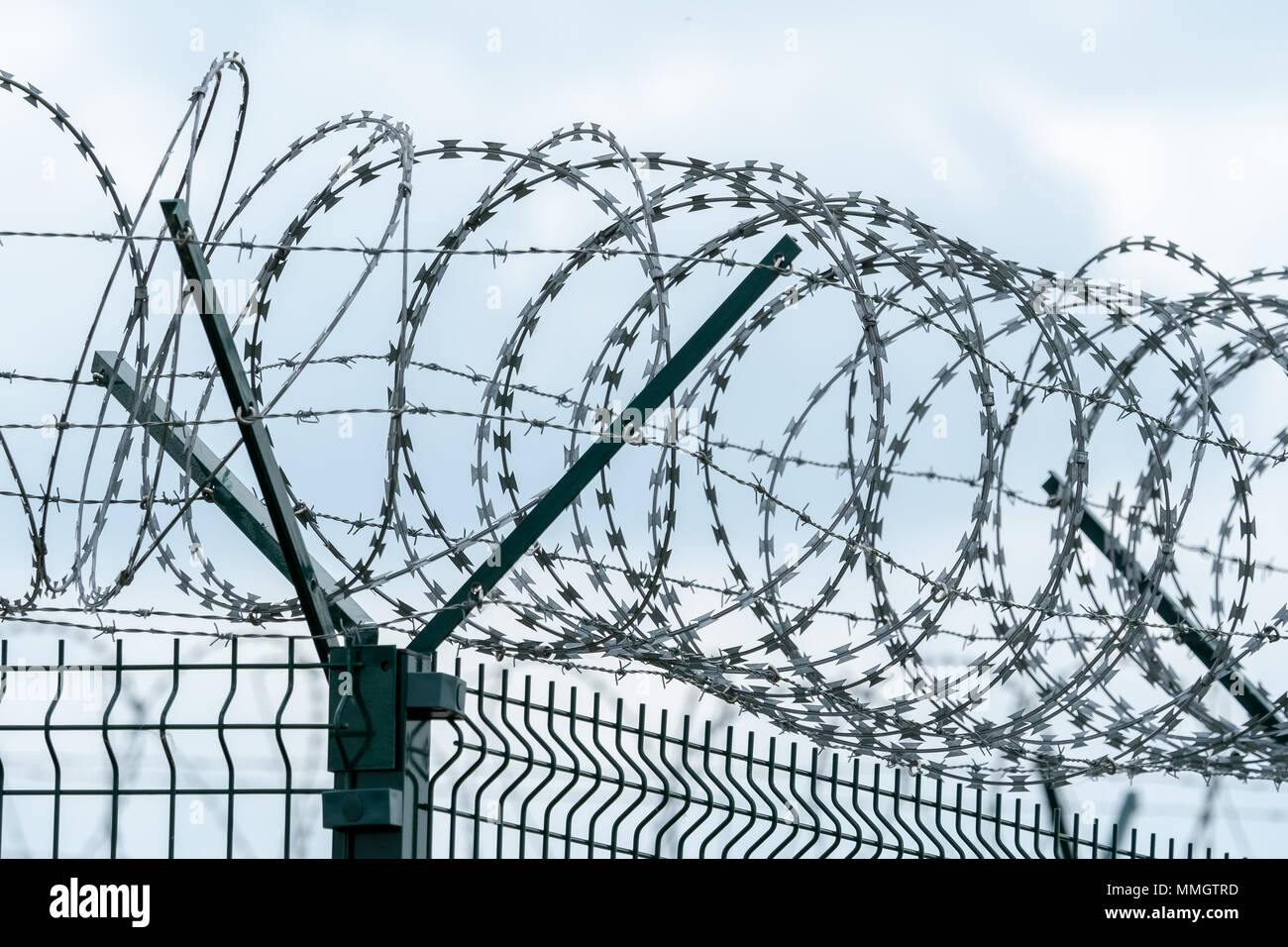 Security fence with a barbed wire. Fence with a barbed wire Stock Photo ...