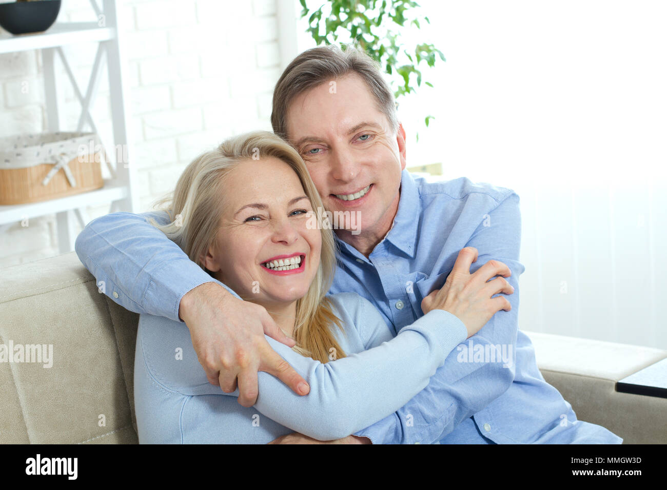 Happy couple in love hug each other on bed at home Stock Photo - Alamy