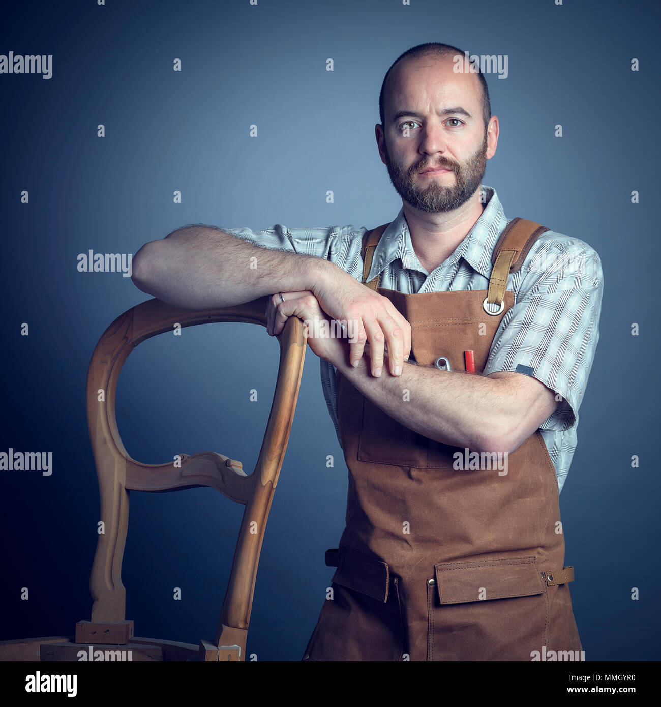portrait of caucasian wood worker with apron studio shot Stock Photo ...