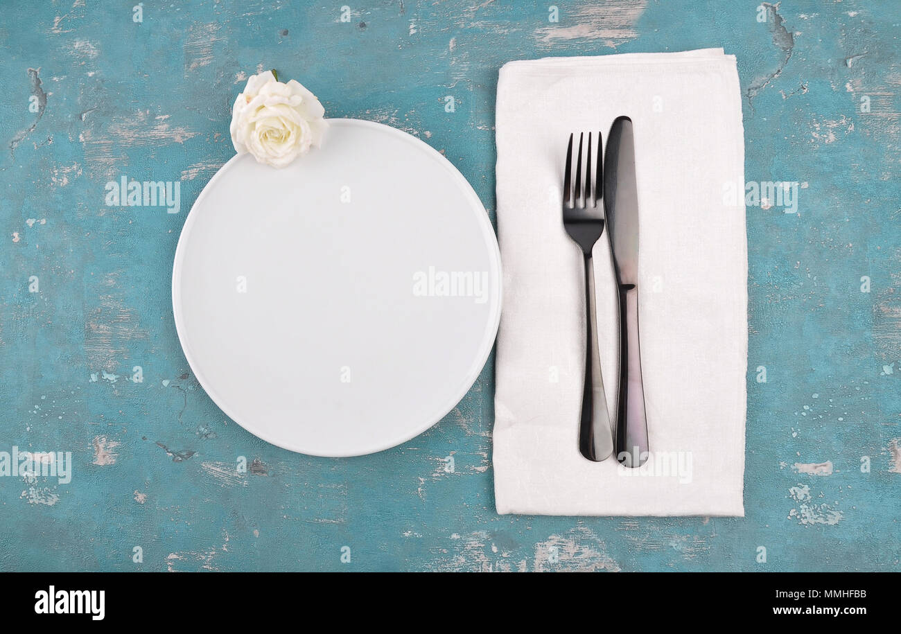 White rose and table setting on weathered background Stock Photo - Alamy