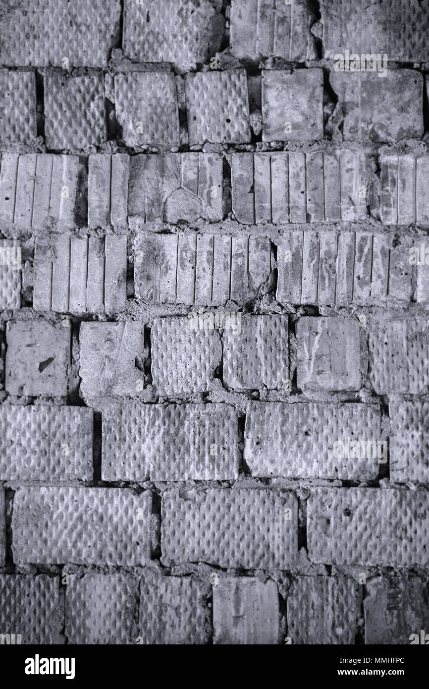 The old wall of a square red brick. Background and texture. Black and ...