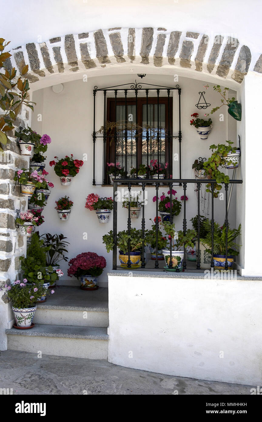 A Spanish house decorated with flowers in the mountain village of ...