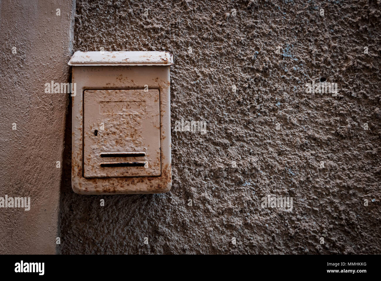 old rusty mailbox on a rustic wall in an alley with copy space Stock ...
