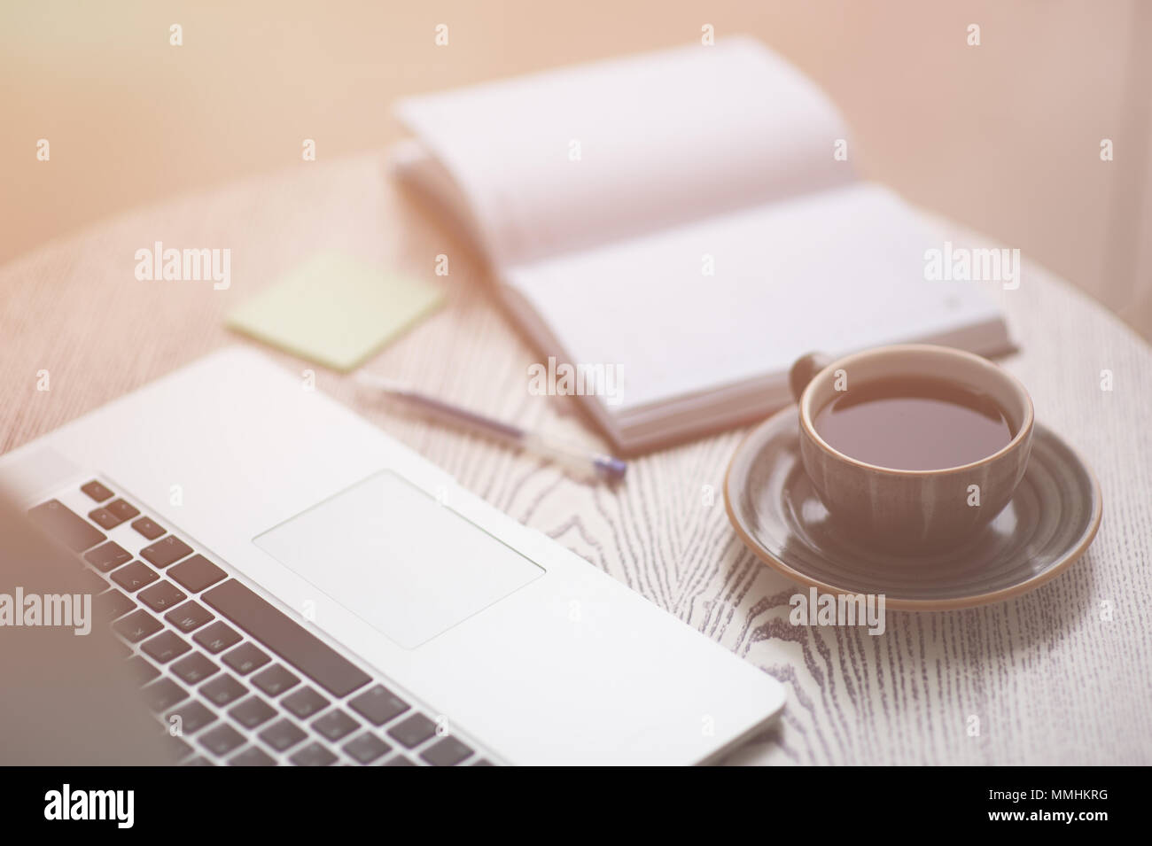 composition laptop, note ,book, pen and cup of tea on wooden table ...
