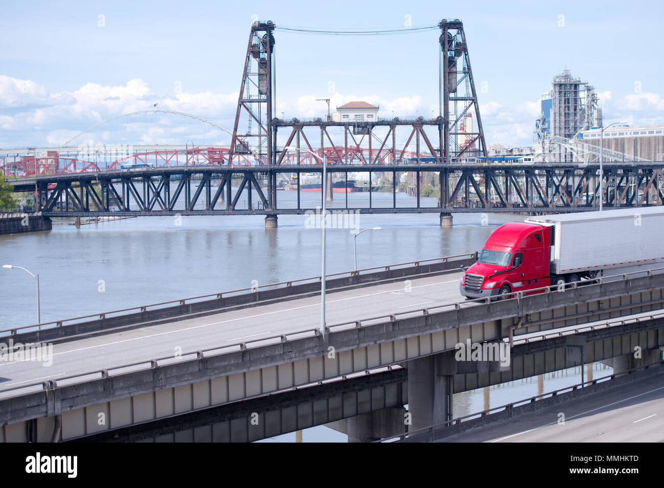 Red big rig semi truck with refrigerator semi trailer transporting ...