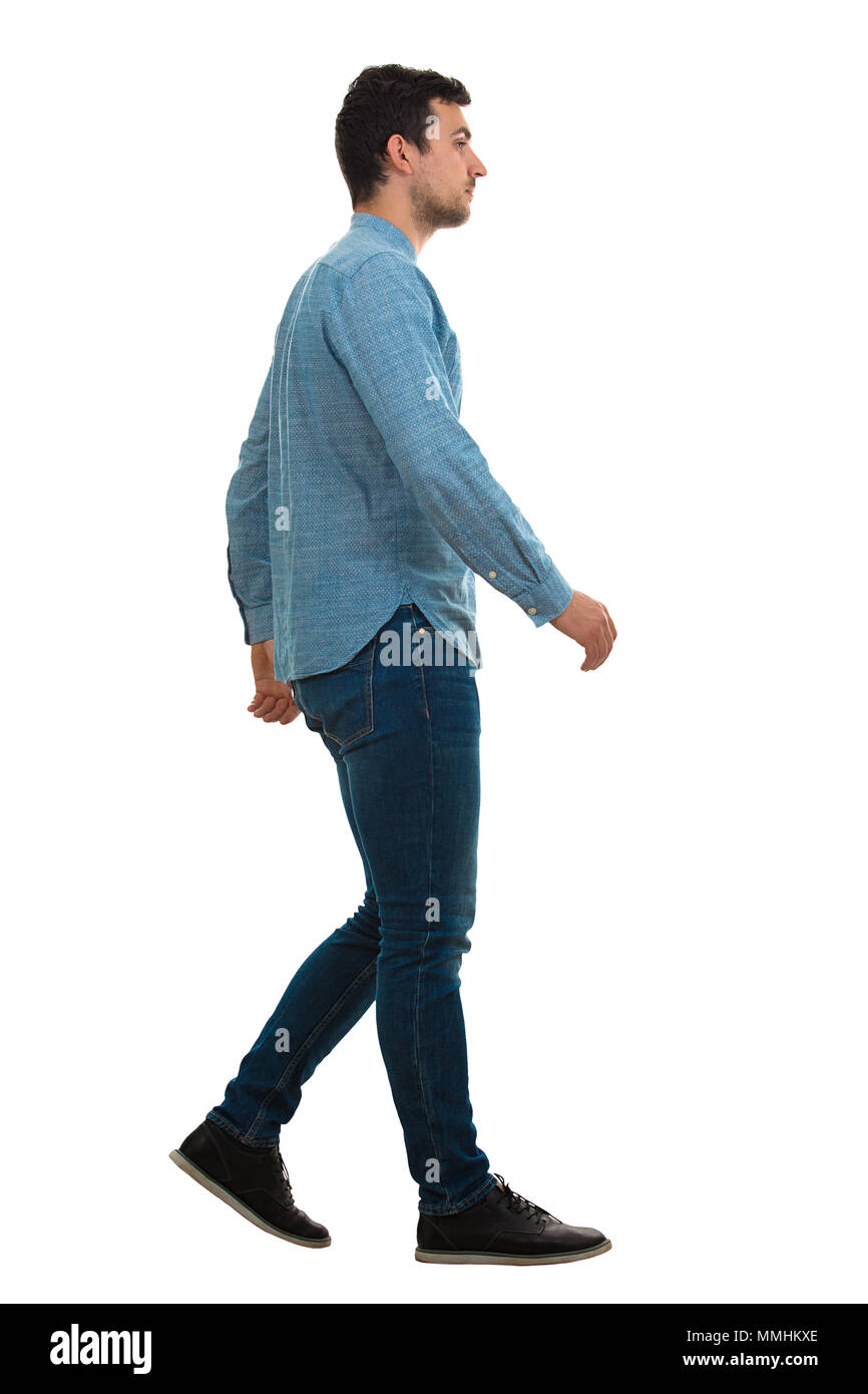 Full length profile shot of a young confident man walking isolated on ...