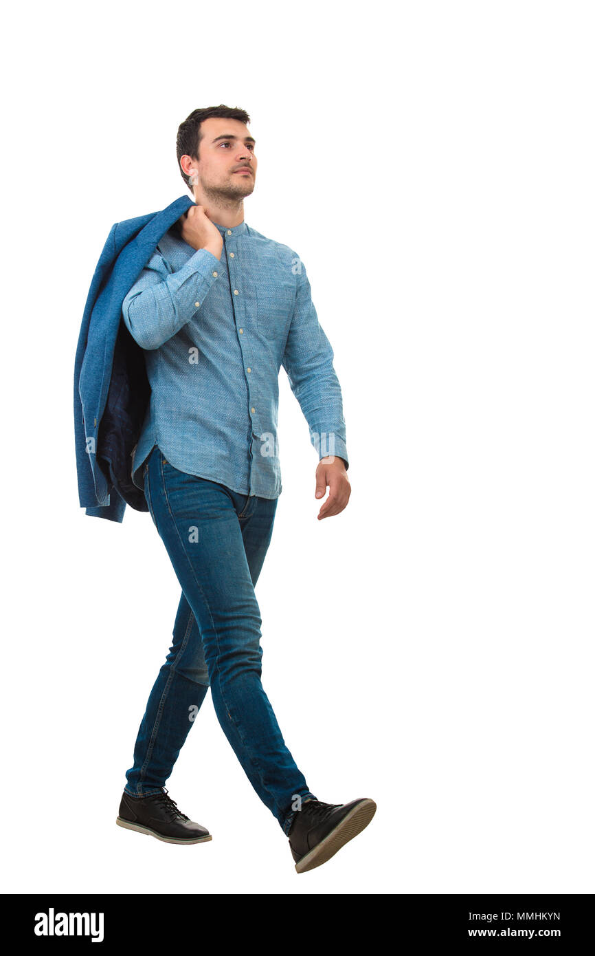 Side view of a proud young businessman carrying his jacket on back over ...