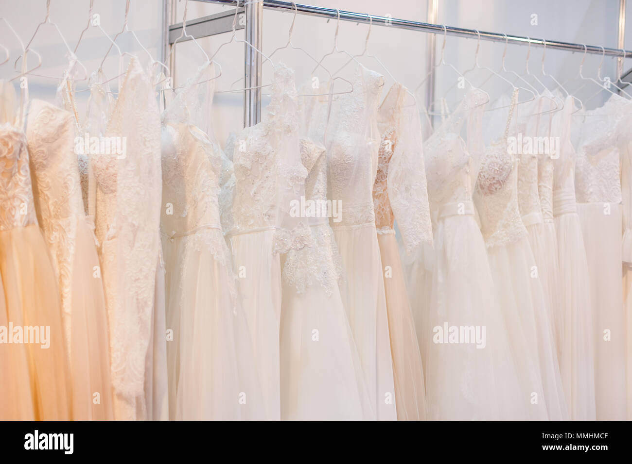 Rack with a lot of beautiful chic wedding dresses Stock Photo - Alamy