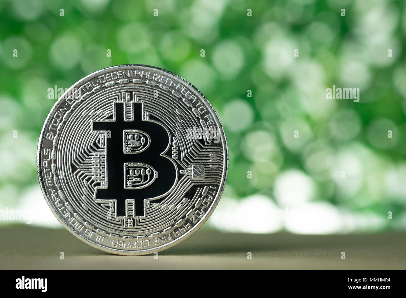 Bitcoin digital currency, bit-coin on green blurred bokeh background, Cryptocurrency money ...