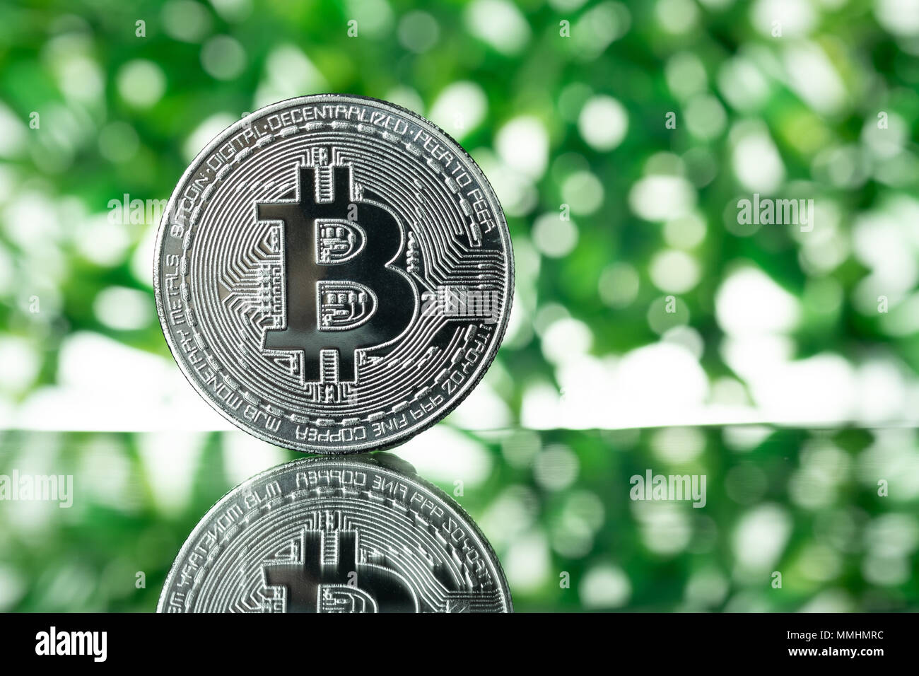 Bitcoin digital currency, bit-coin on green blurred bokeh background, Cryptocurrency money ...